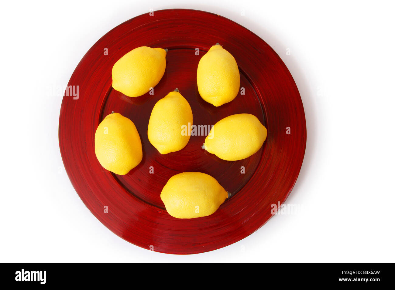 Six Lemons on a Red Plate Stock Photo - Alamy