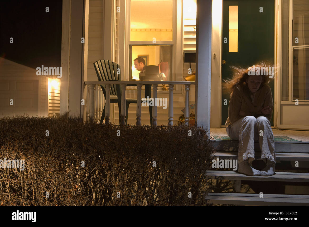 Woman sitting outside of her house Stock Photo - Alamy