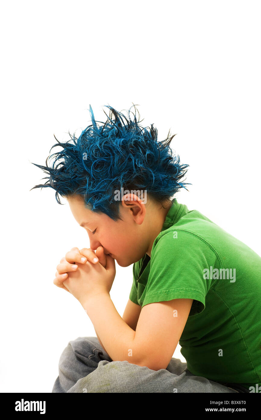 Boy with blue hair praying Stock Photo - Alamy