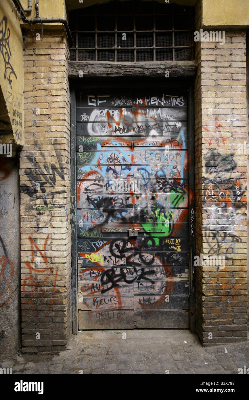 graffiti covering back street door Stock Photo - Alamy