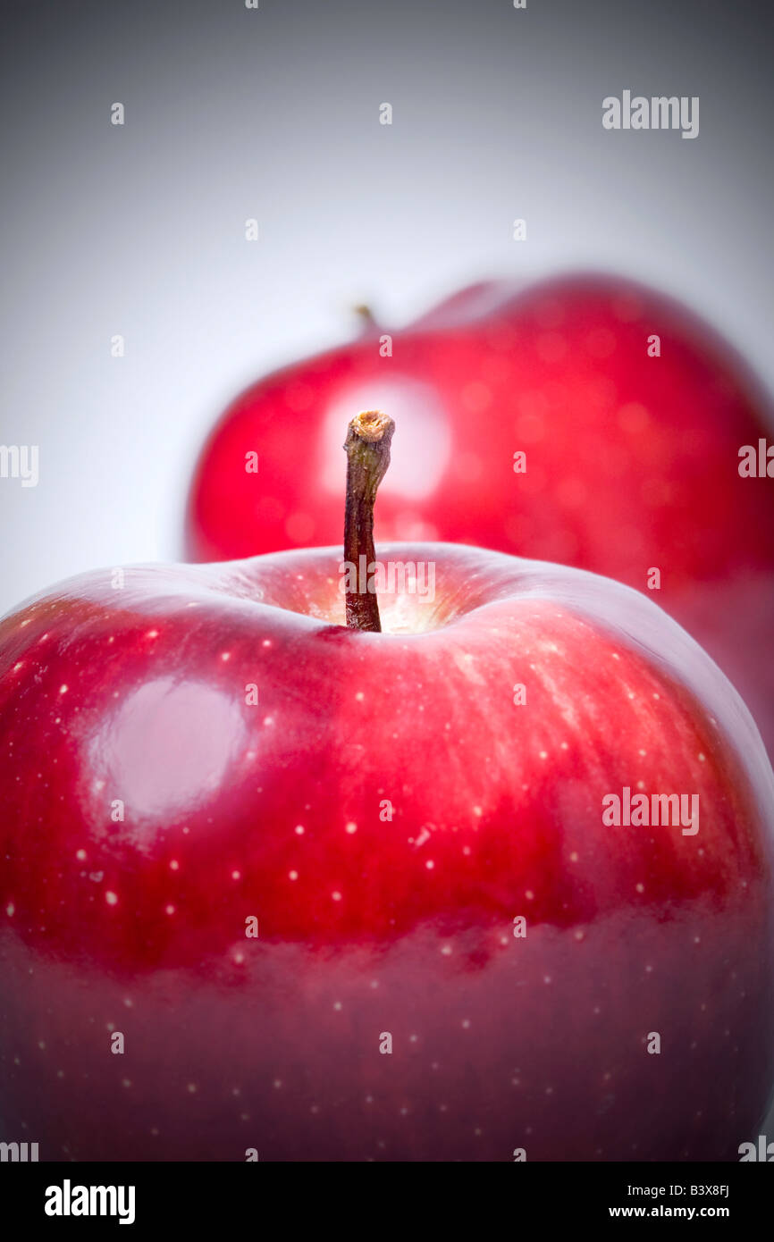 Two red apples close up in front of grey background Stock Photo - Alamy