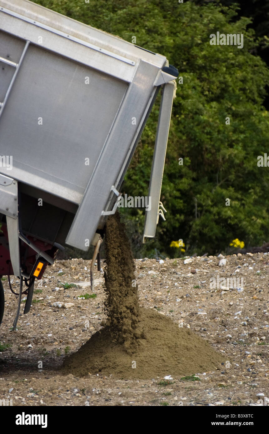 A dump truck pours aggregate gravel Stock Photo - Alamy