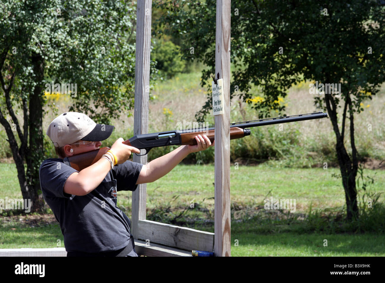 A boy shooting at a target at a skeet shooting range in Wisconsin Stock ...