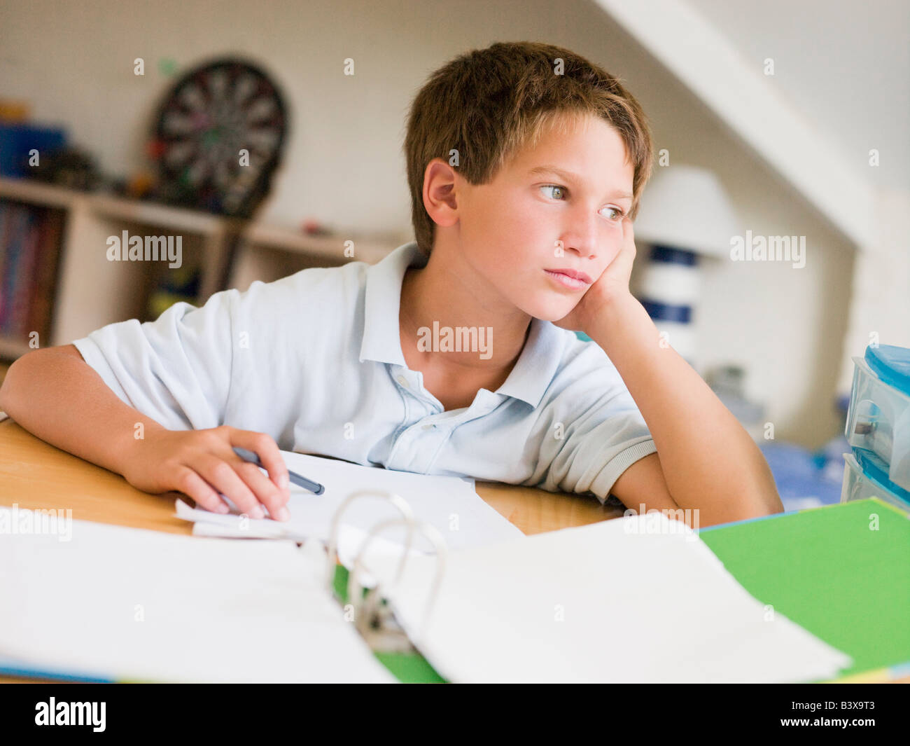 Young Boy Doing Homework In His Room Stock Photo - Alamy