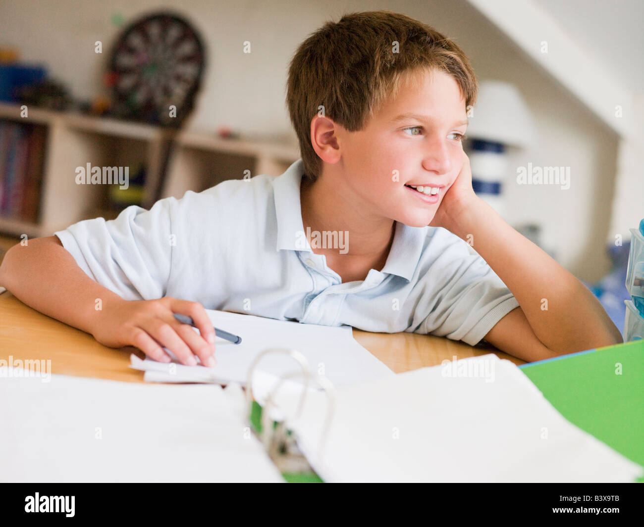 Young Boy Doing Homework In His Room Stock Photo - Alamy
