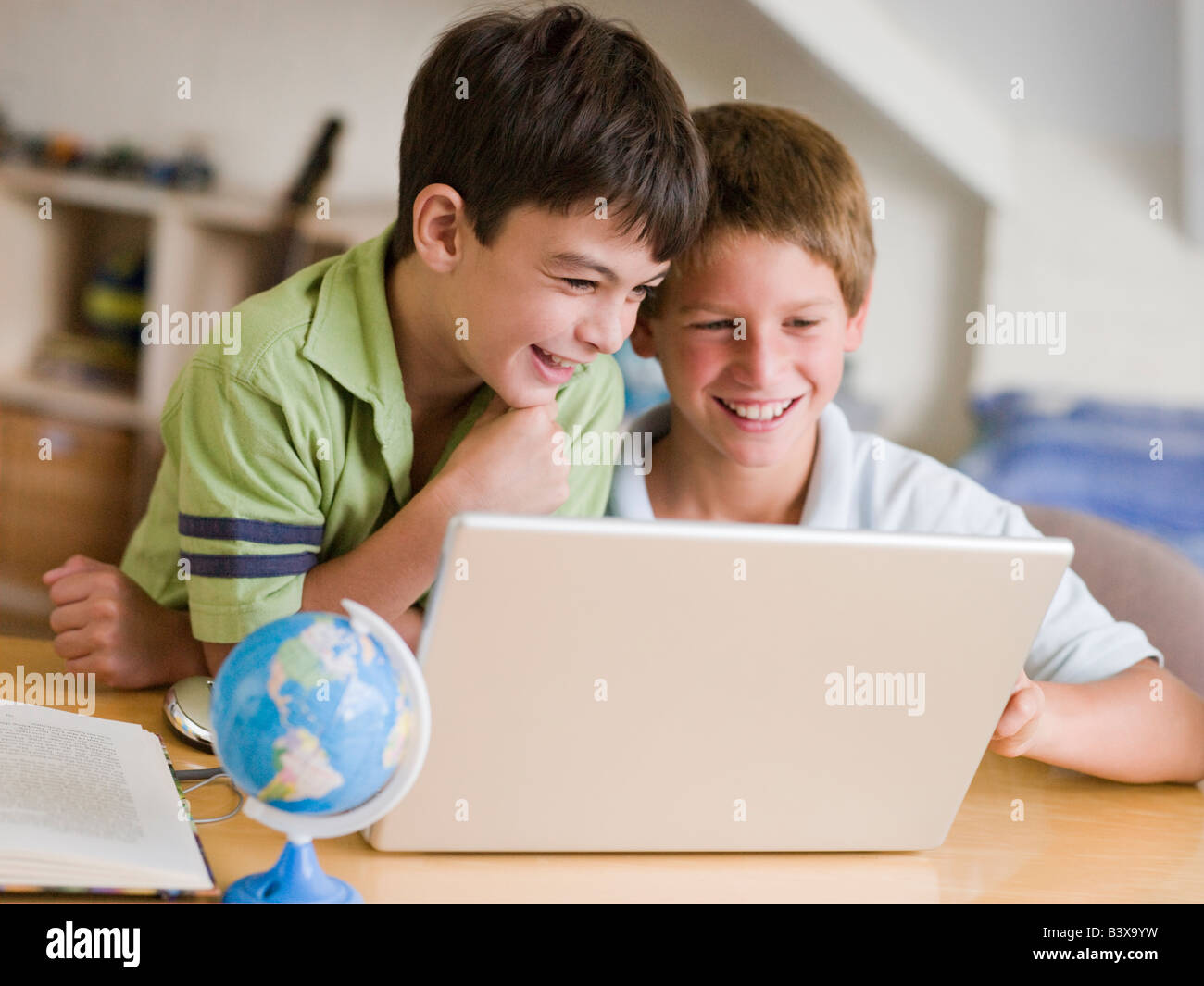 Two Young Boys Using A Laptop At Home Stock Photo - Alamy