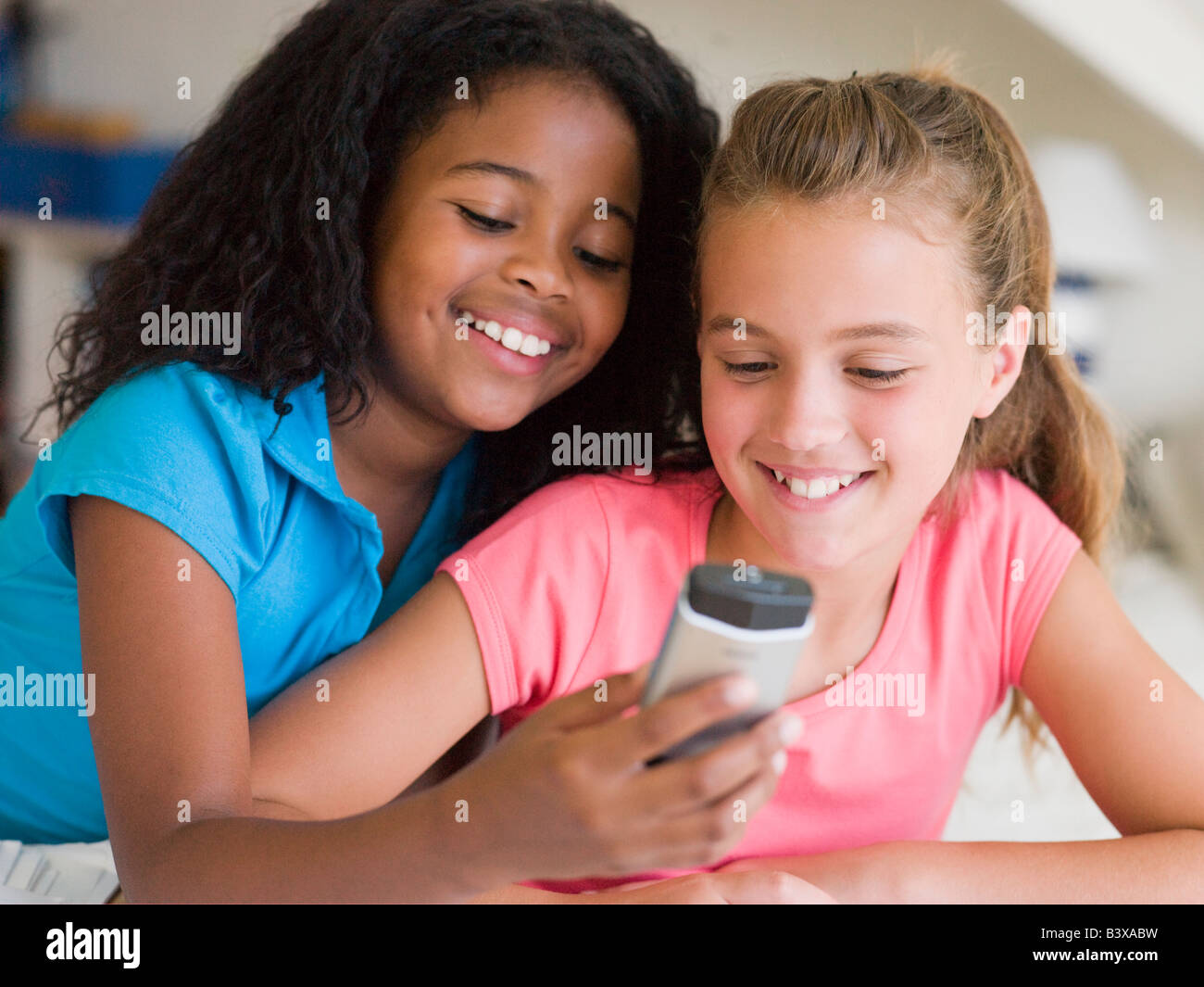 Young Girls Playing With A Cellphone Stock Photo - Alamy