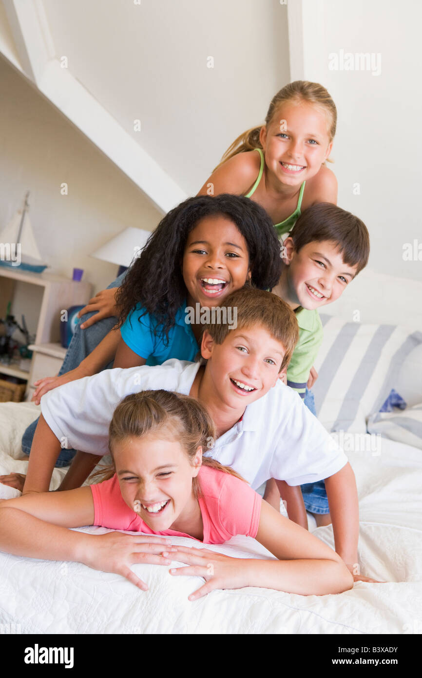Five Young Friends Lying On Top Of Each Other Stock Photo - Alamy