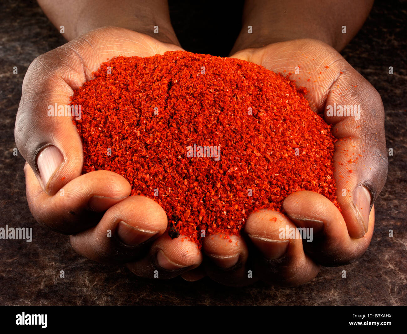 MAN HOLDING CHILLI POWDER Stock Photo - Alamy
