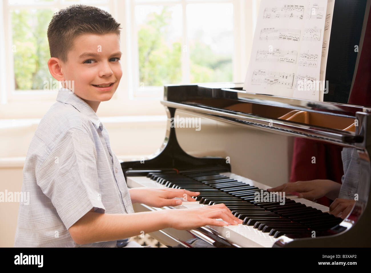 Pre teen boy playing piano hi-res stock photography and images - Alamy