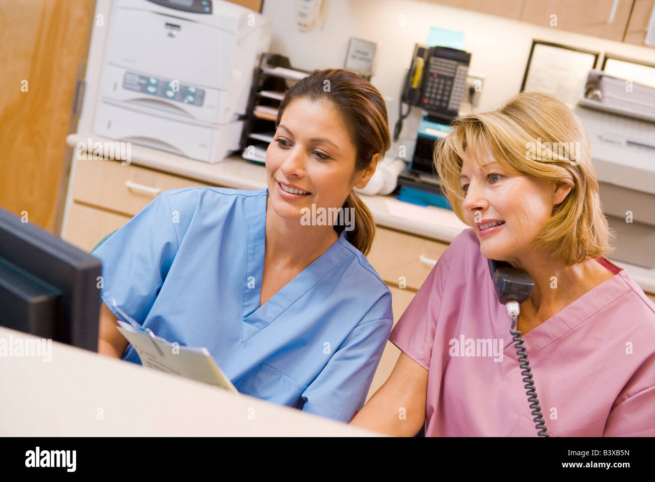 Nurses At The Reception Area In A Hospital Stock Photo - Alamy
