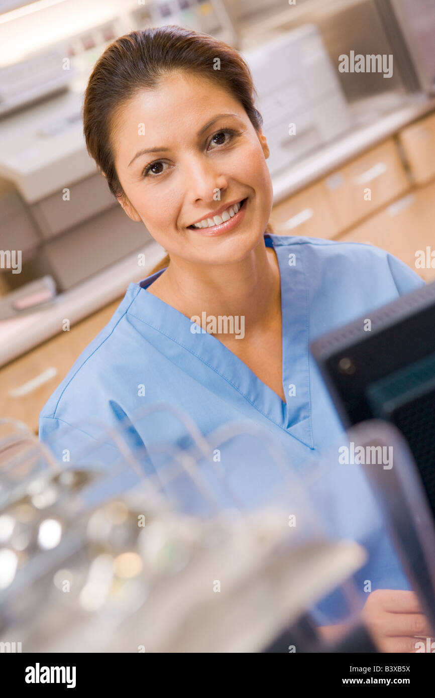 A Nurse Sitting At A Computer At The Reception Area Of A Hospital Stock ...