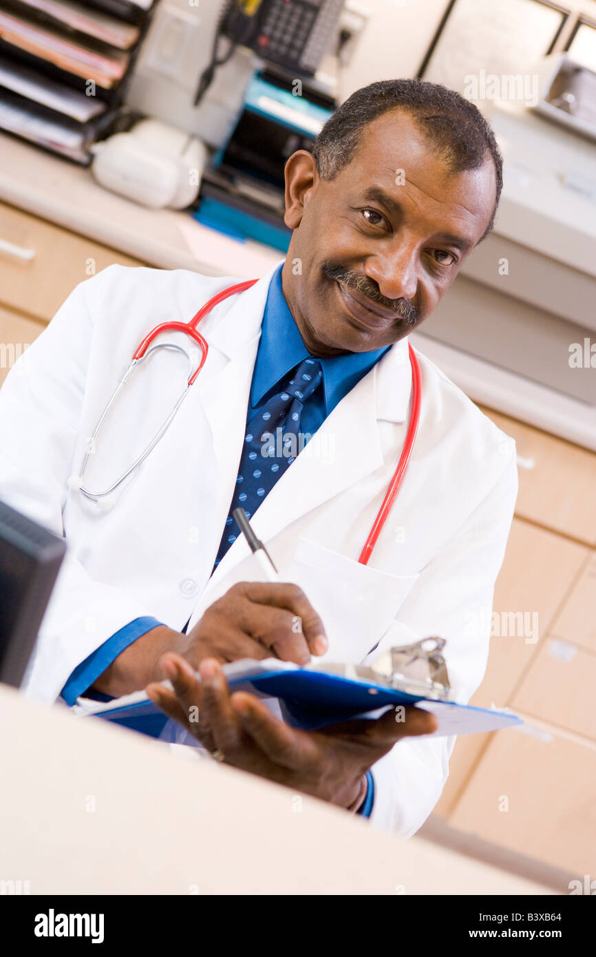 A Doctor Writing On A Clipboard At The Reception Area Of A Hospital ...