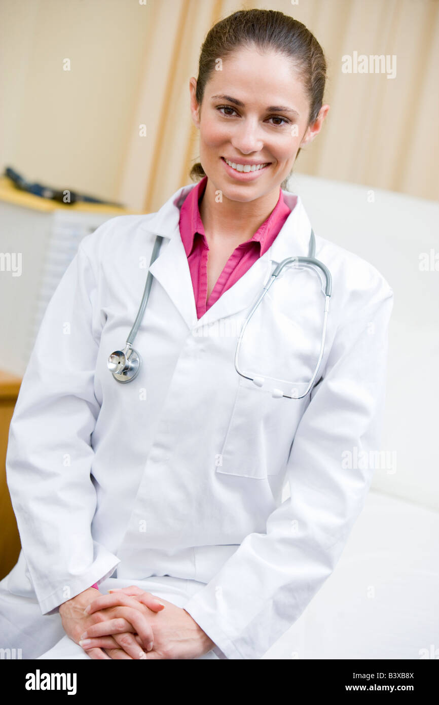 A Doctor Sitting On A Hospital Bed Stock Photo - Alamy