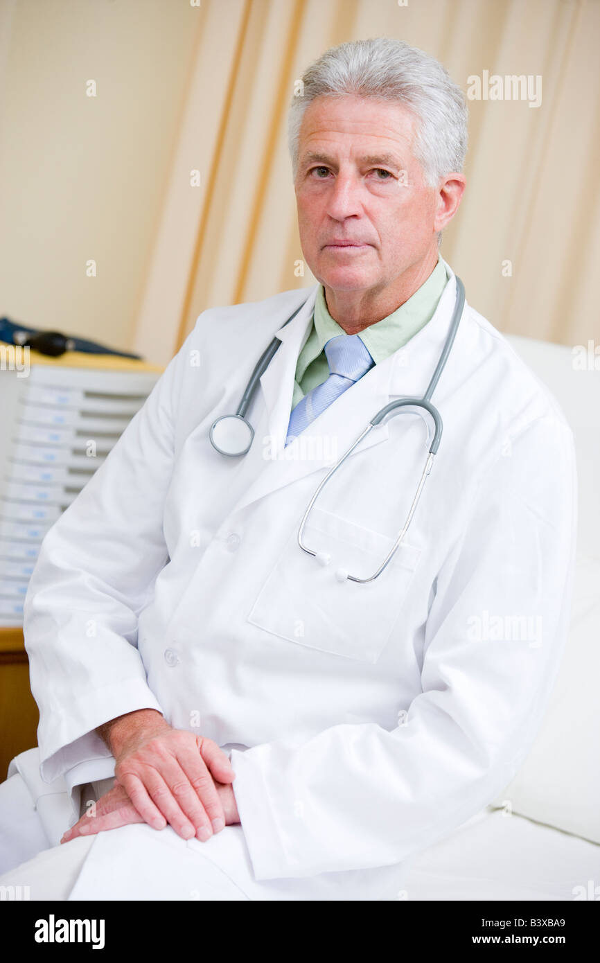 A Doctor Sitting On A Hospital Bed Stock Photo - Alamy