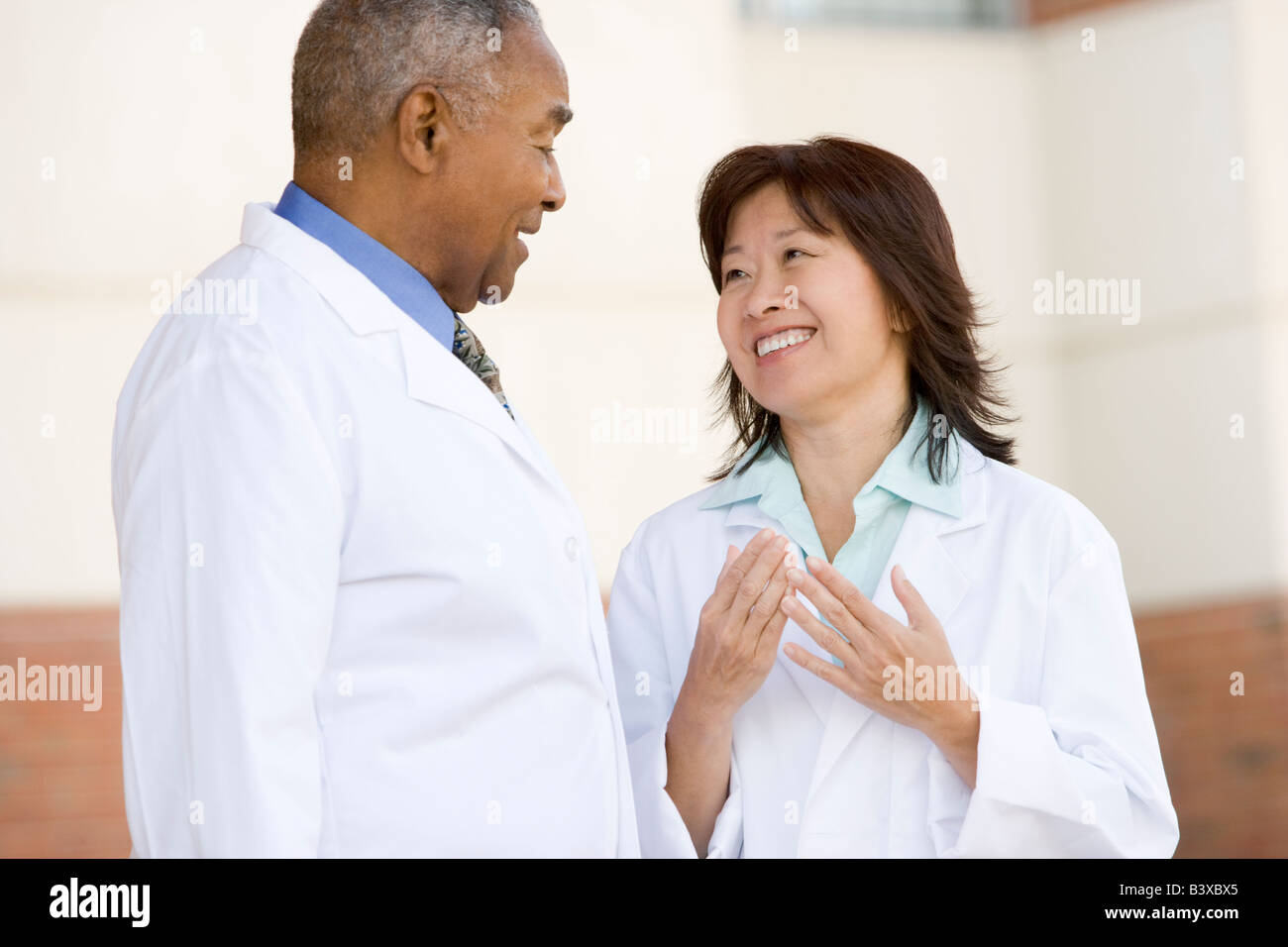 Two Doctors Standing Outside A Hospital Stock Photo - Alamy