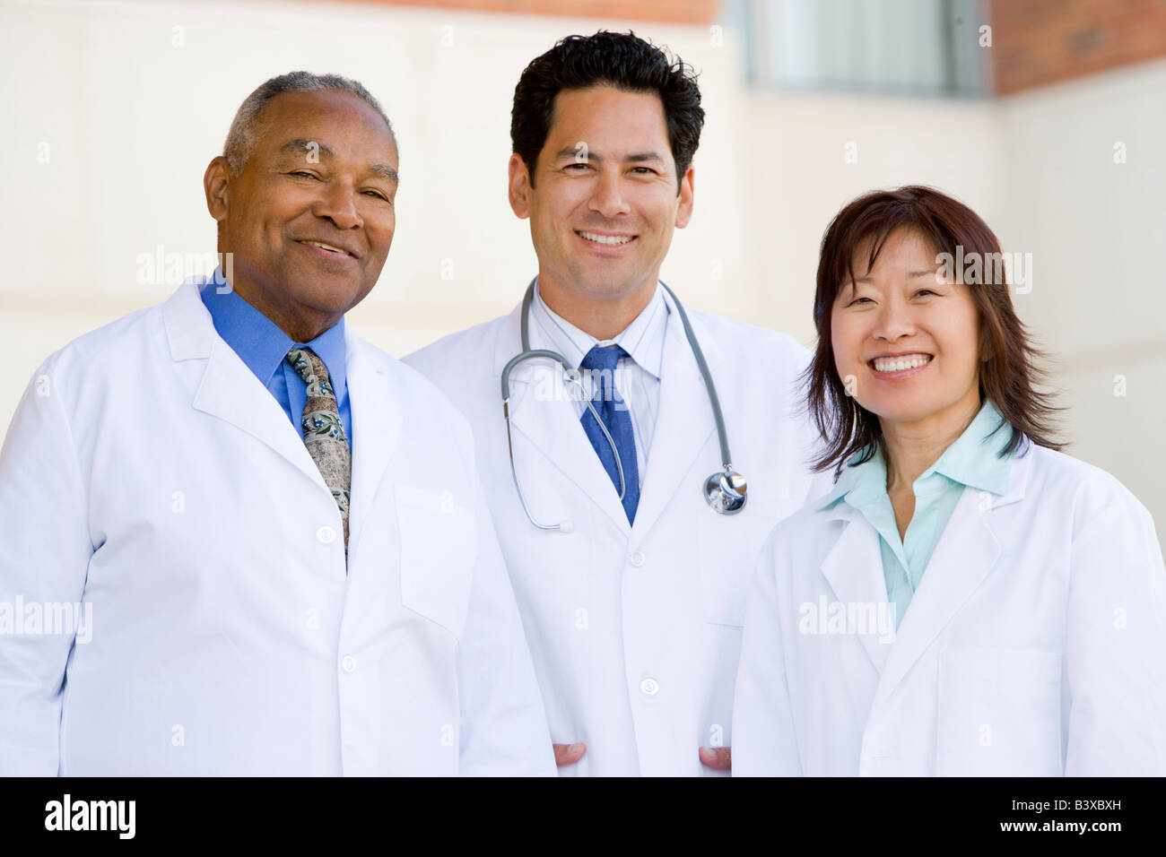 Three Doctors Standing Outside A Hospital Stock Photo - Alamy