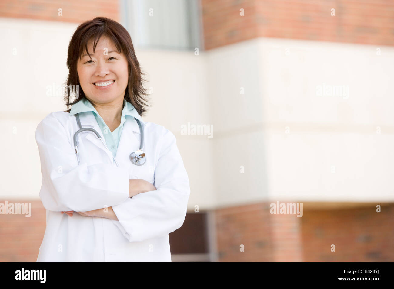 Doctor Standing Outside A Hospital Stock Photo - Alamy