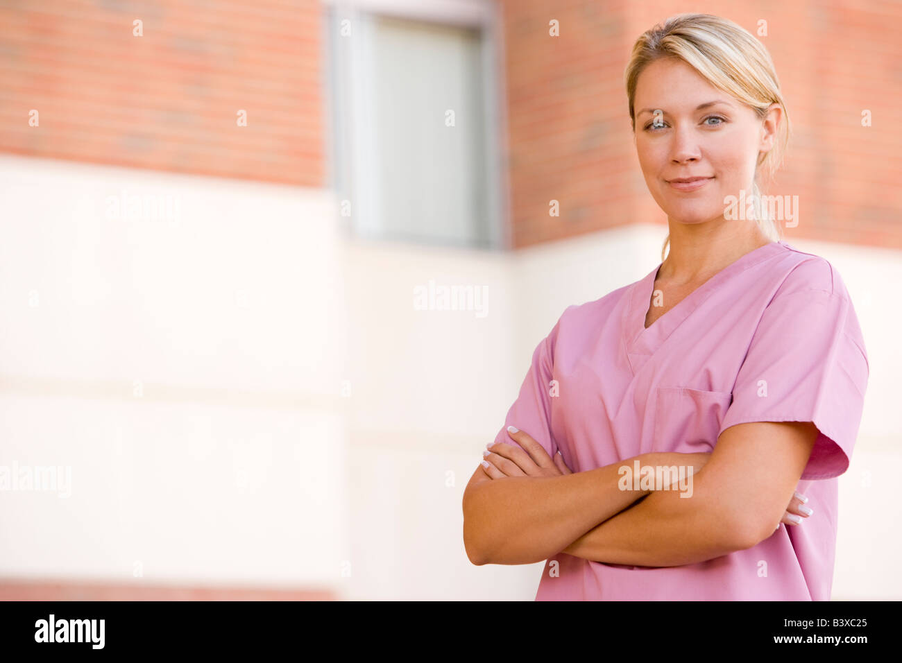 Nurse Standing Outside A Hospital Stock Photo - Alamy