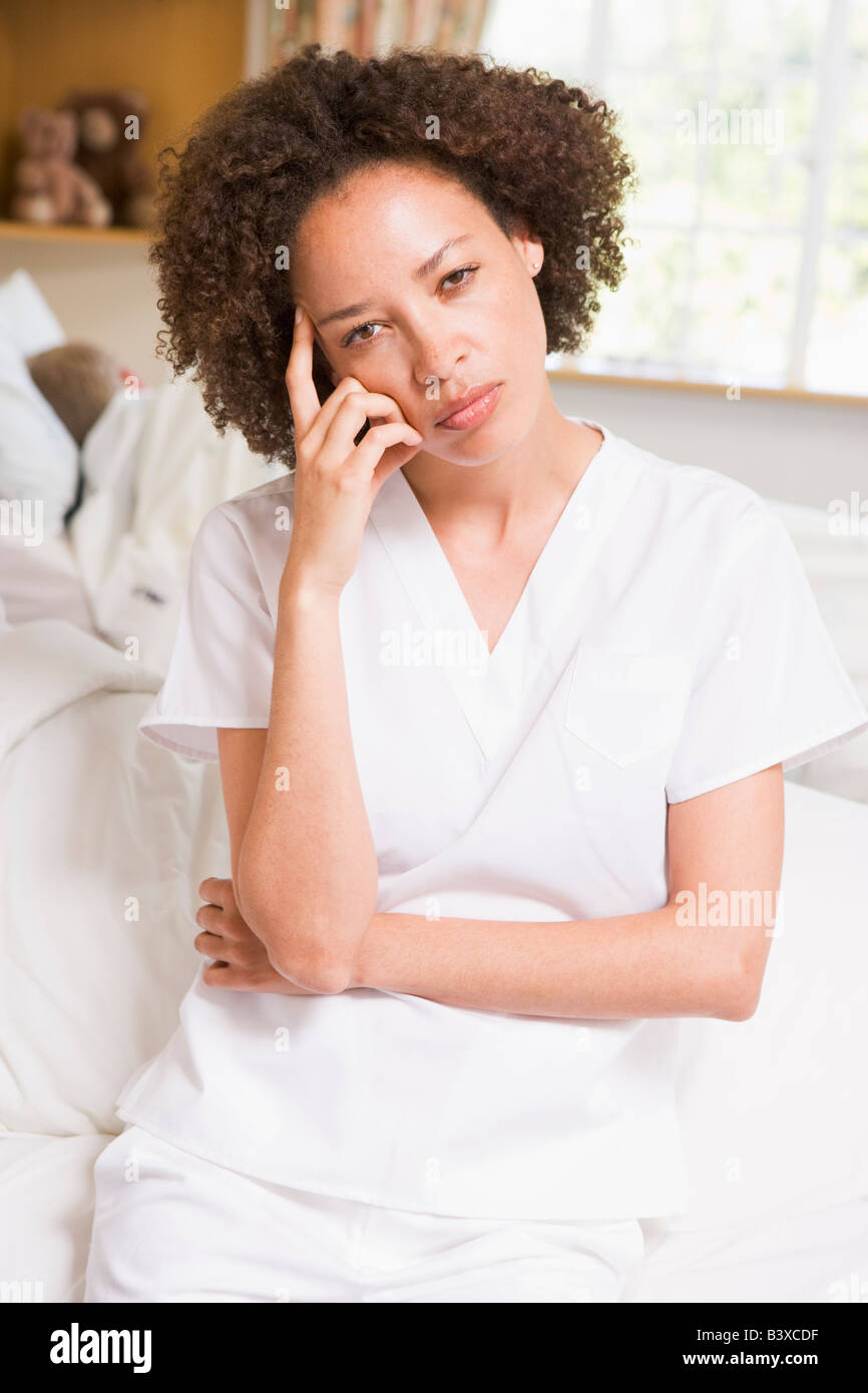 Nurse Sitting On Hospital Bed Stock Photo - Alamy