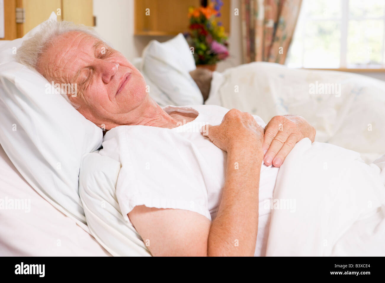 Senior Man Asleep In Hospital Bed Stock Photo - Alamy