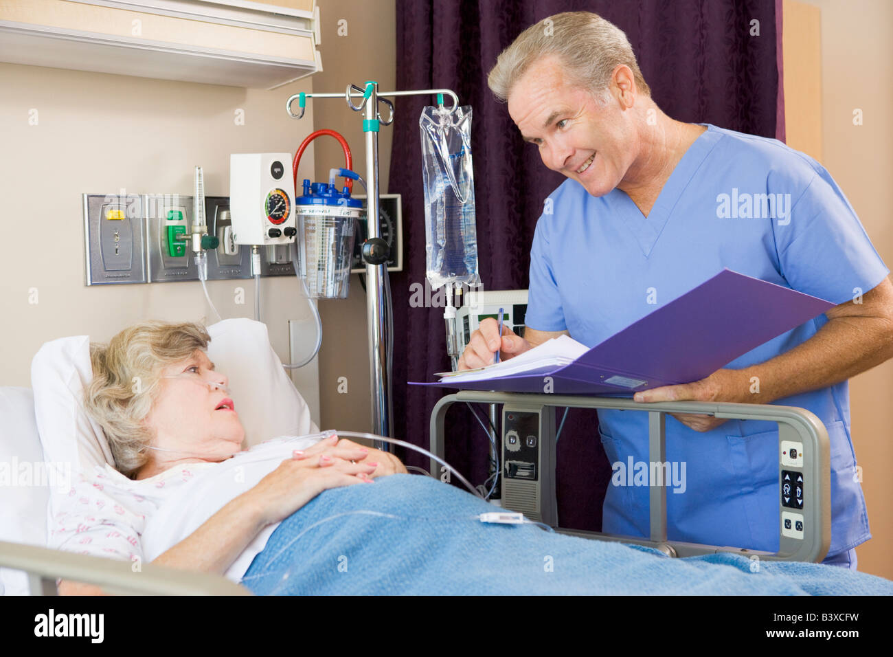 Doctor Making Notes About Senior Woman Patient Stock Photo - Alamy