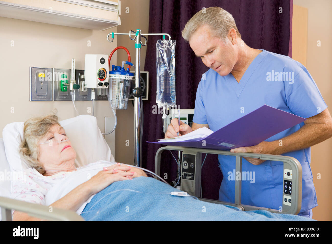 Doctor Making Notes About Patient Stock Photo - Alamy