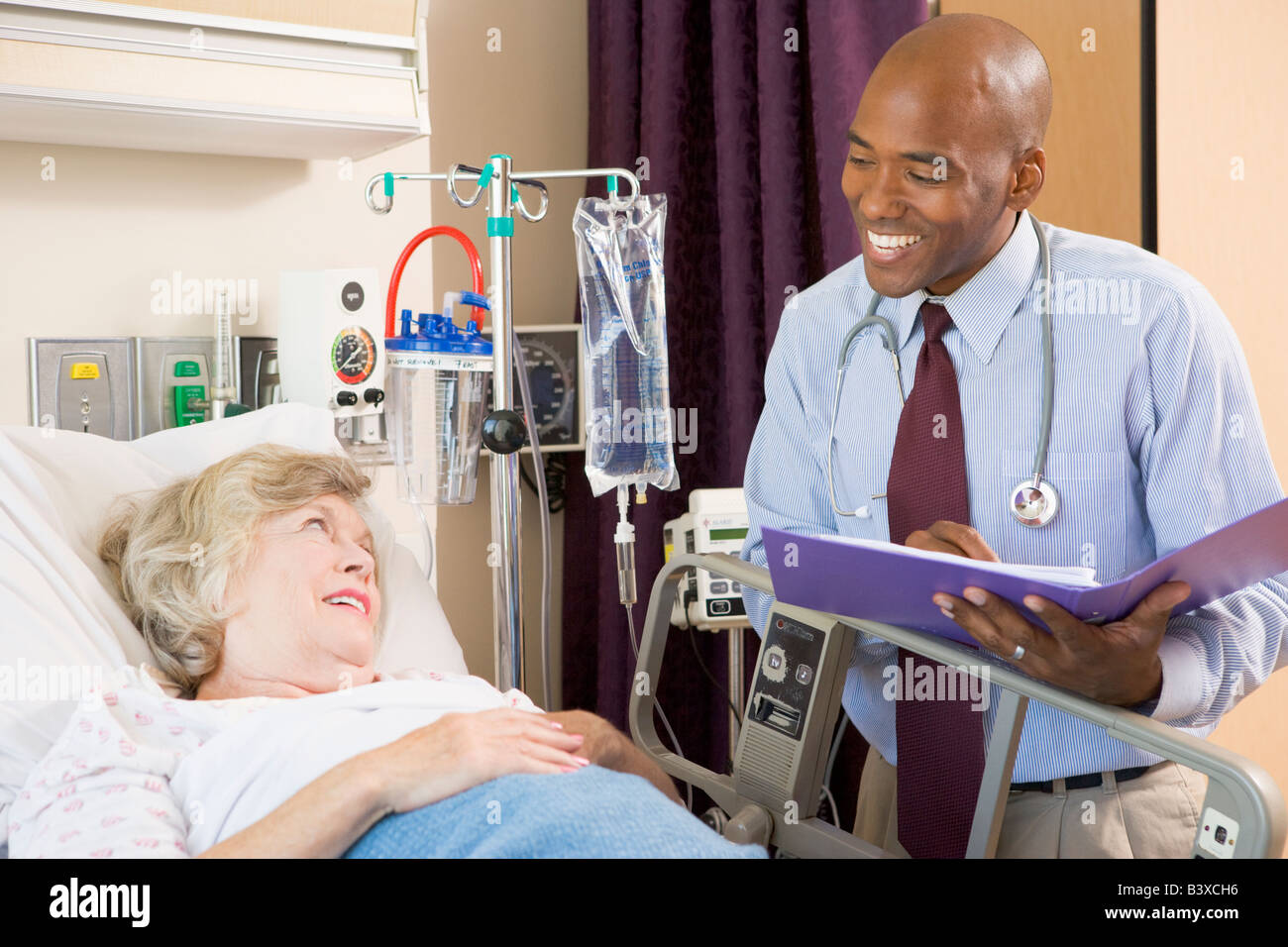 Doctor Making Notes About Patient Stock Photo - Alamy