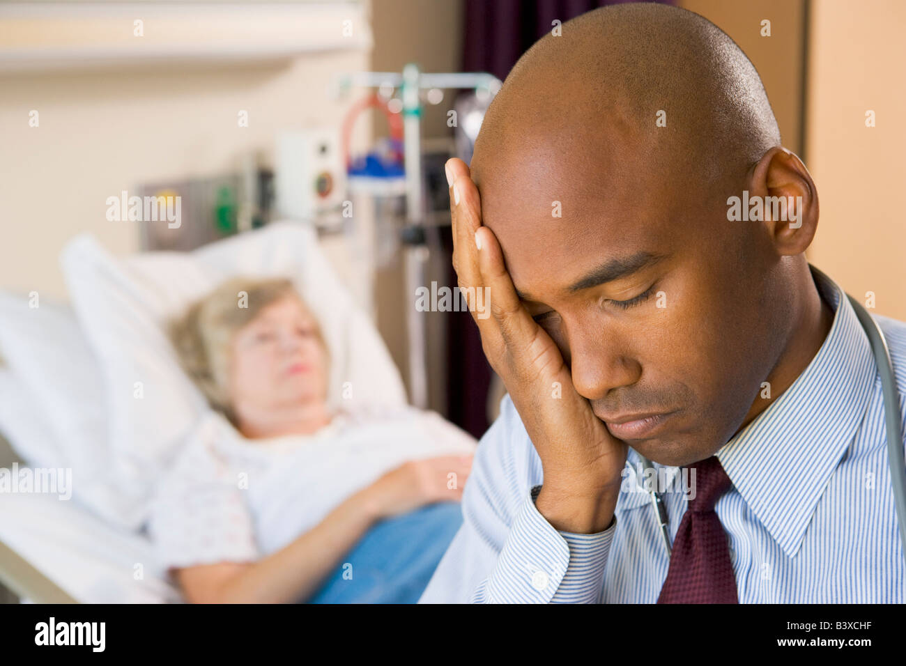 Doctor Looking Tired And Frustrated In Hospital Room Stock Photo - Alamy