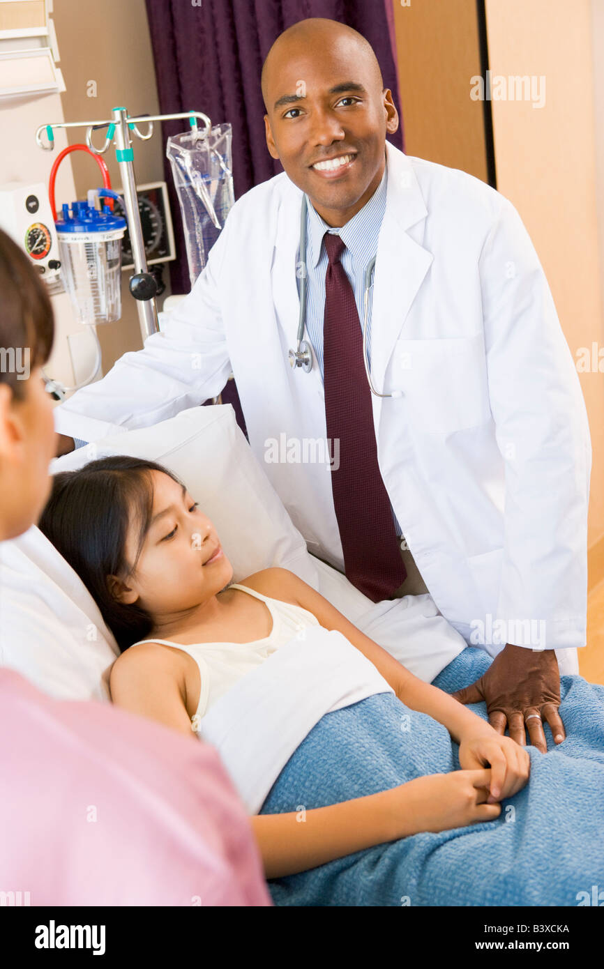 Doctor Standing In Hospital Room With Patient Stock Photo - Alamy