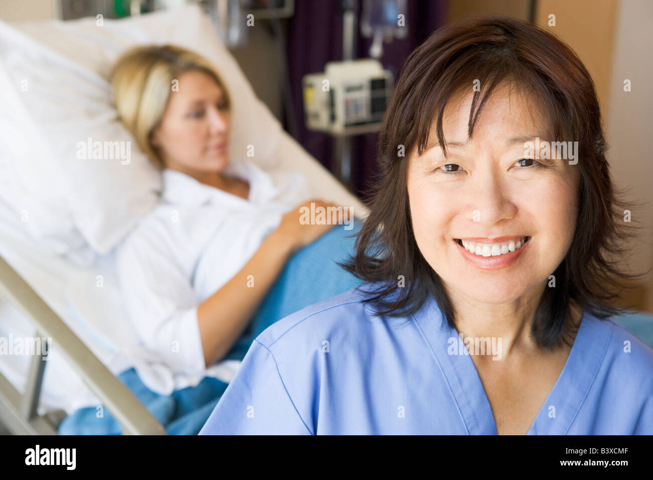 Doctor Standing In Patients Room, Smiling Stock Photo - Alamy