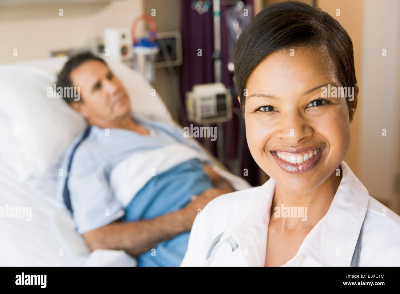 Doctor Smiling In Hospital Room Stock Photo - Alamy