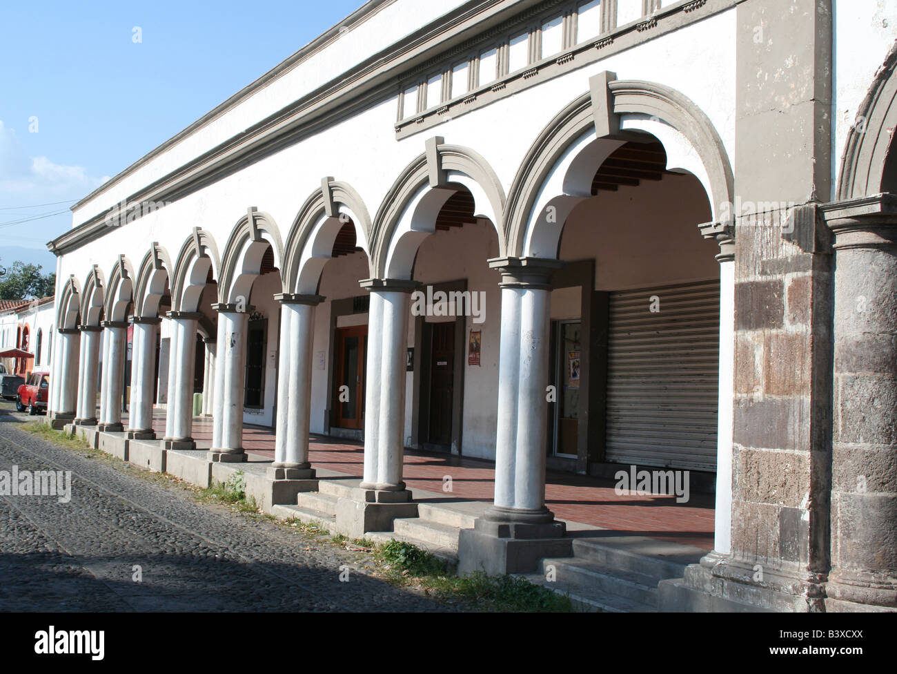 old mexican street front building arches Stock Photo - Alamy