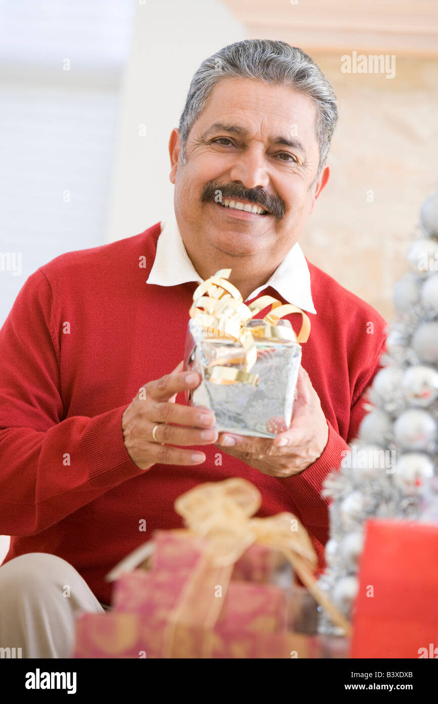 Man Excited To Open Christmas Present Stock Photo - Alamy
