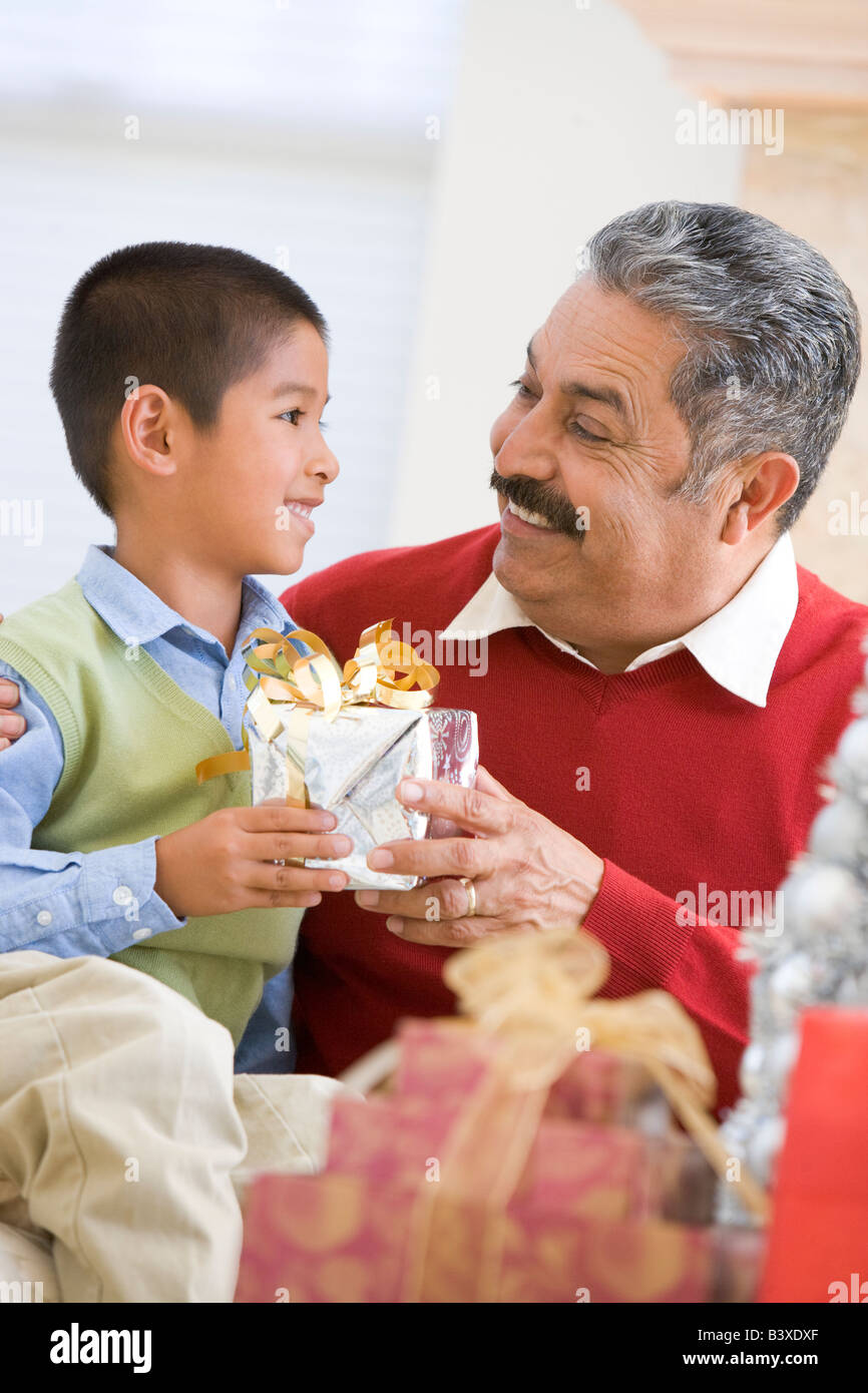 Boy Surprising Father With Christmas Present Stock Photo - Alamy