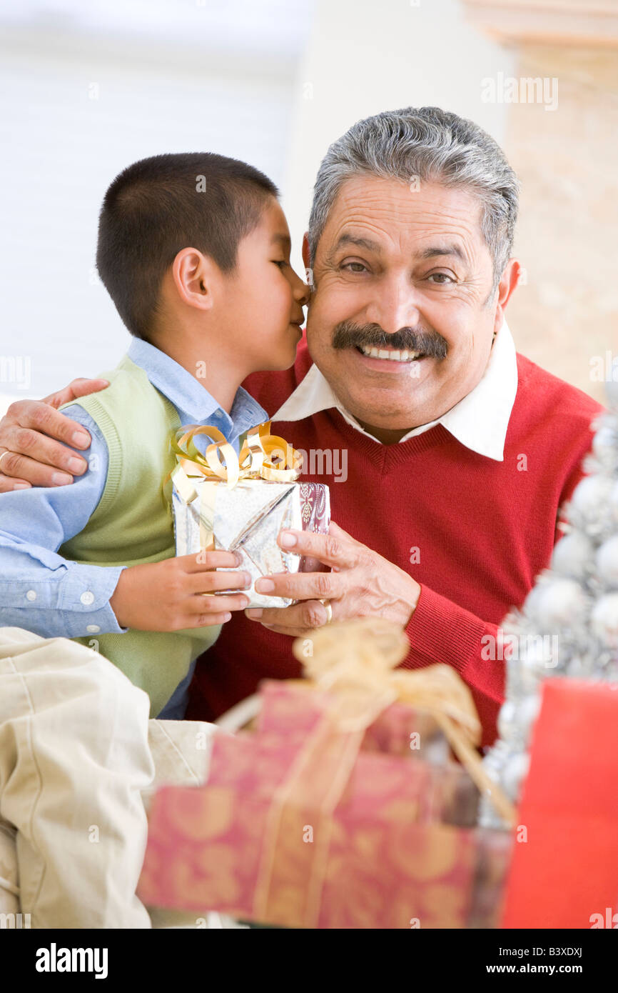 Boy Surprising Father With Christmas Present Stock Photo - Alamy