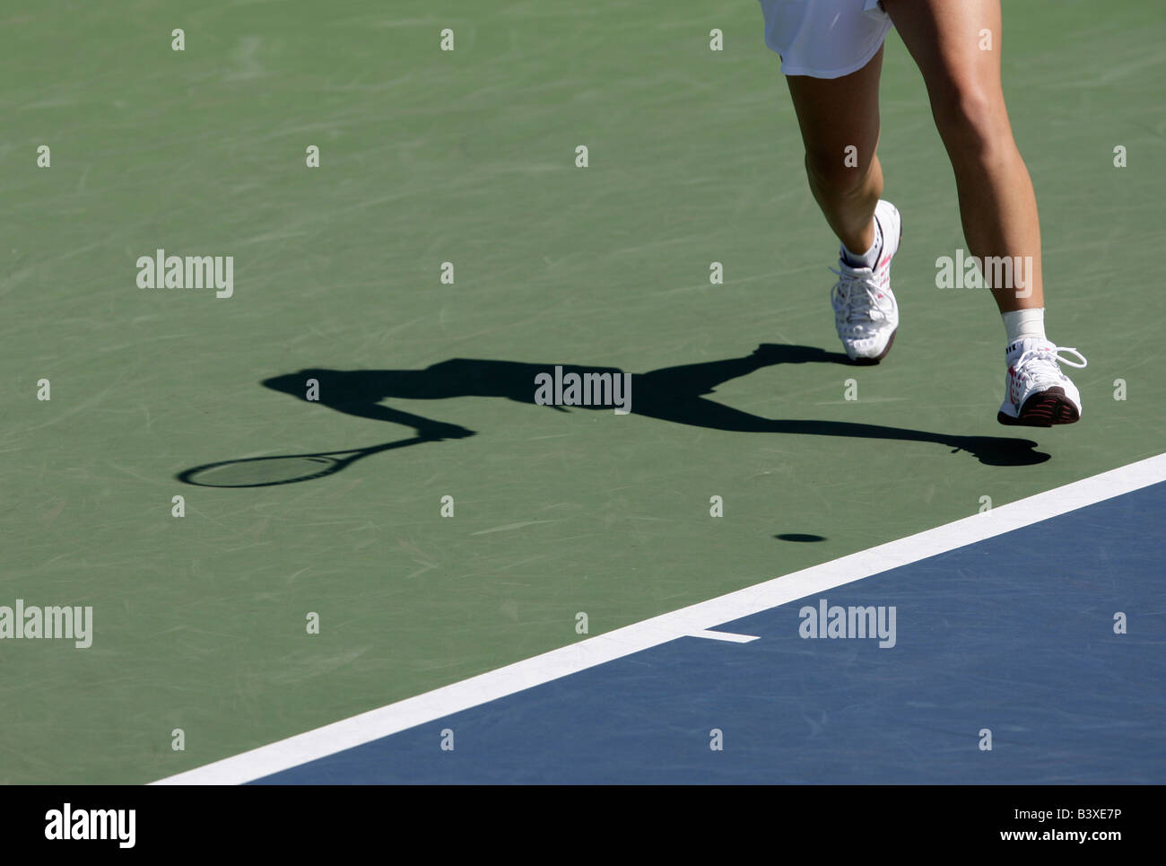 Shadow of a tennis player in action Stock Photo - Alamy
