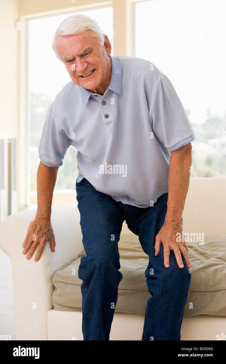 Senior Man Trying To Sit Down Stock Photo - Alamy
