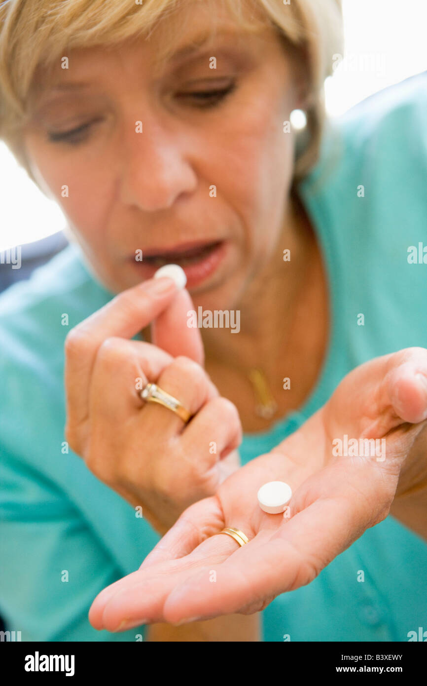 Woman Taking Pills Stock Photo - Alamy