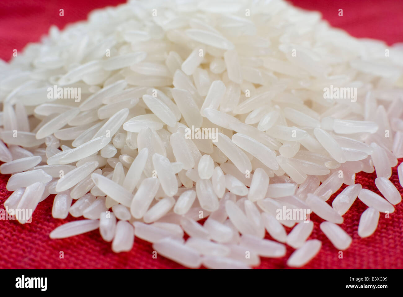 Rice granules on a crimson red background Stock Photo - Alamy
