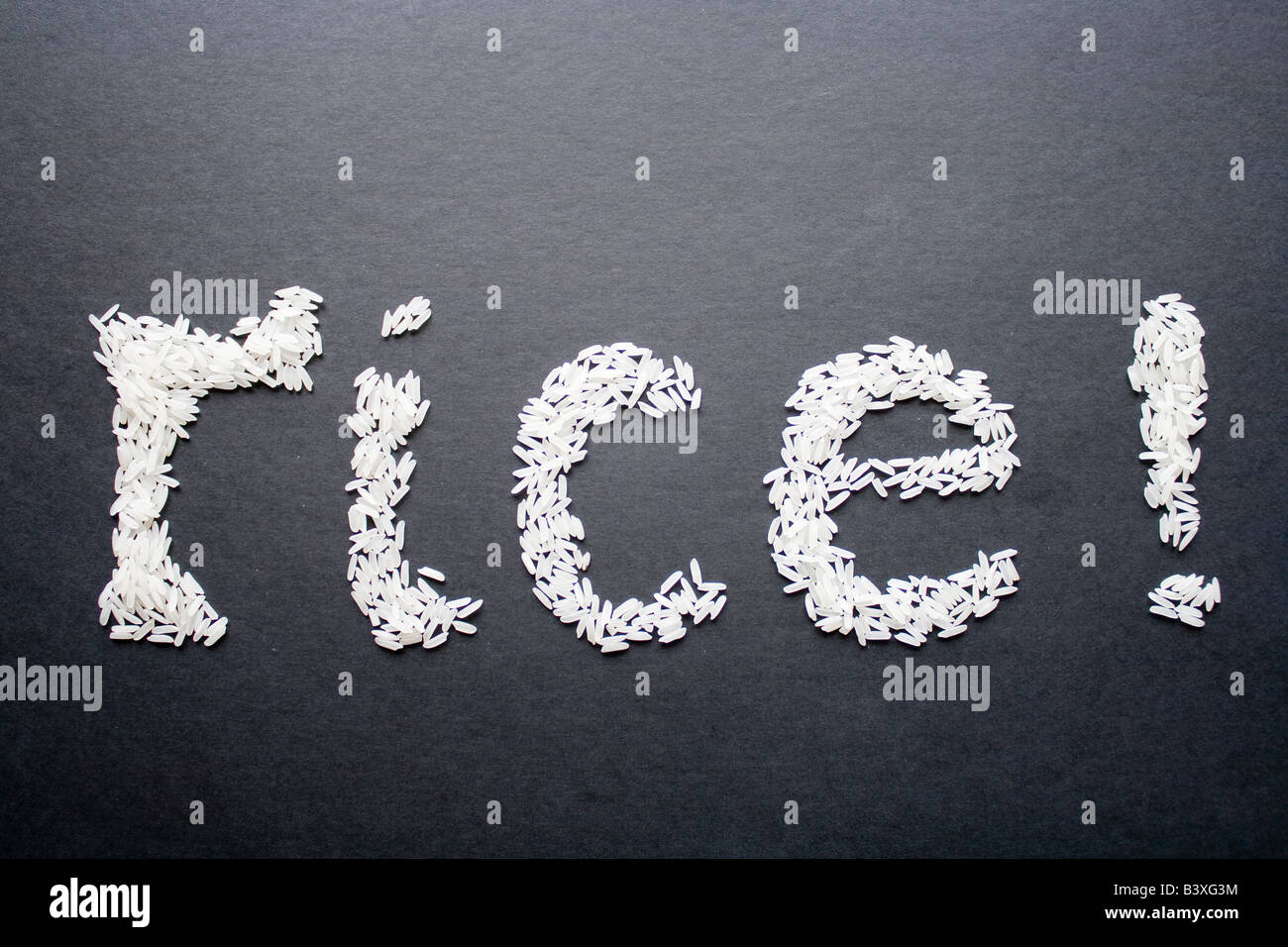 Rice grains spelling the word rice on a dark background Stock Photo - Alamy