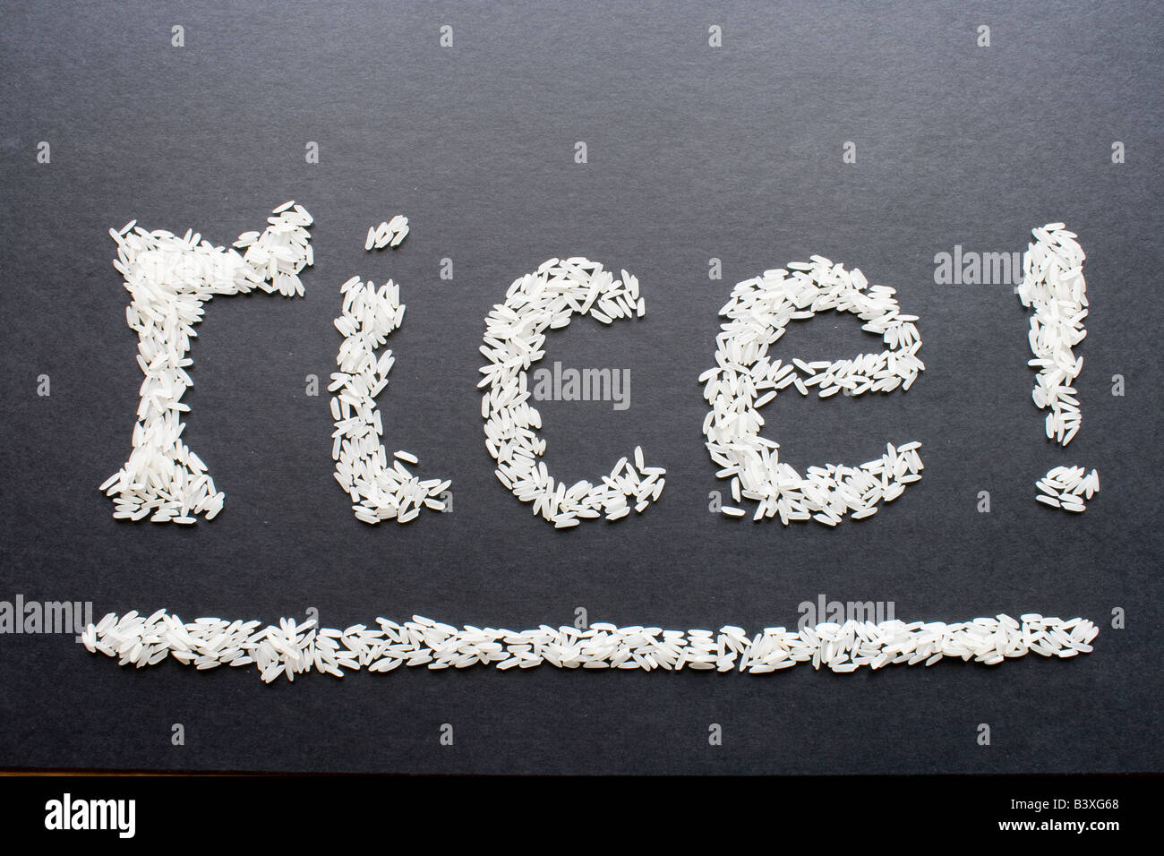 Rice grains spelling the word rice on a dark background Stock Photo - Alamy