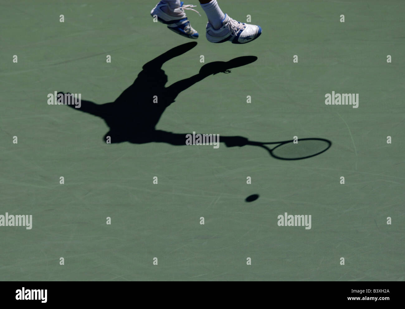 Shadow of a tennis player in action Stock Photo - Alamy