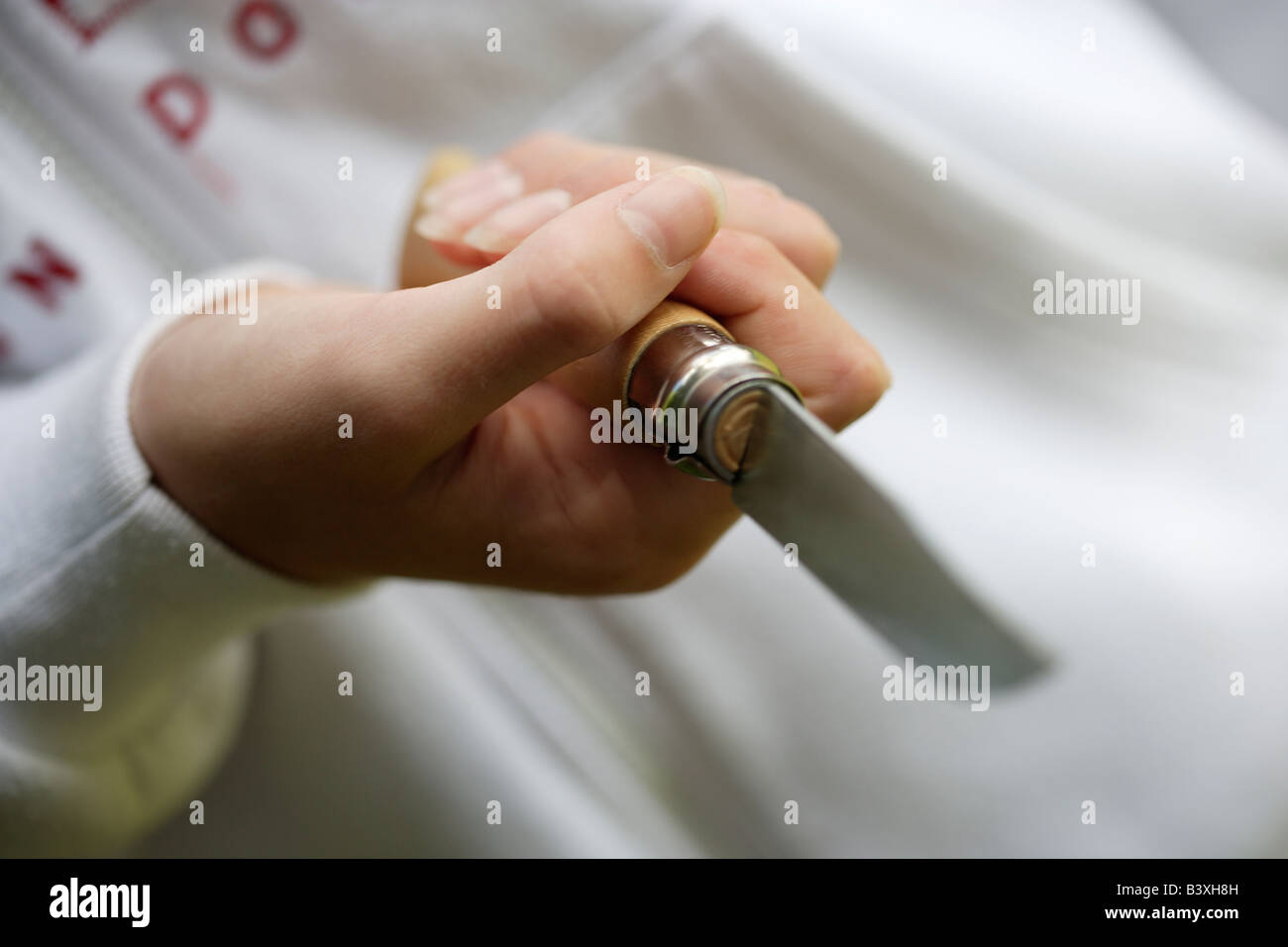 Boy with knife in hand Stock Photo - Alamy
