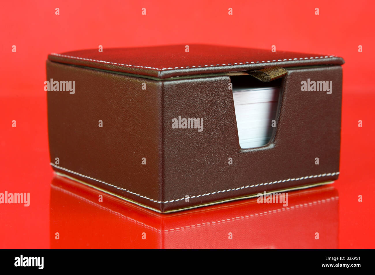 A note block isolated against a red background Stock Photo - Alamy