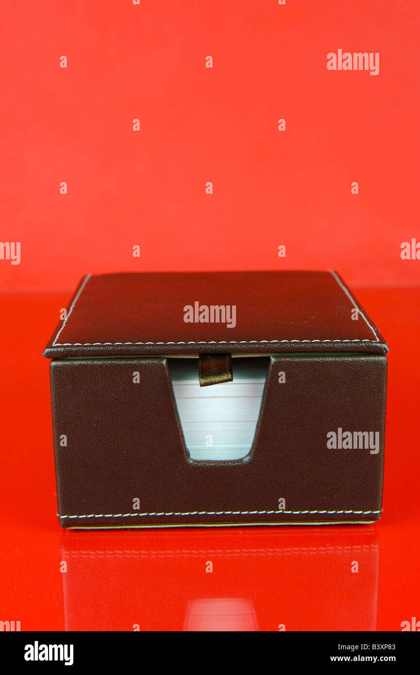 A note block isolated against a red background Stock Photo - Alamy