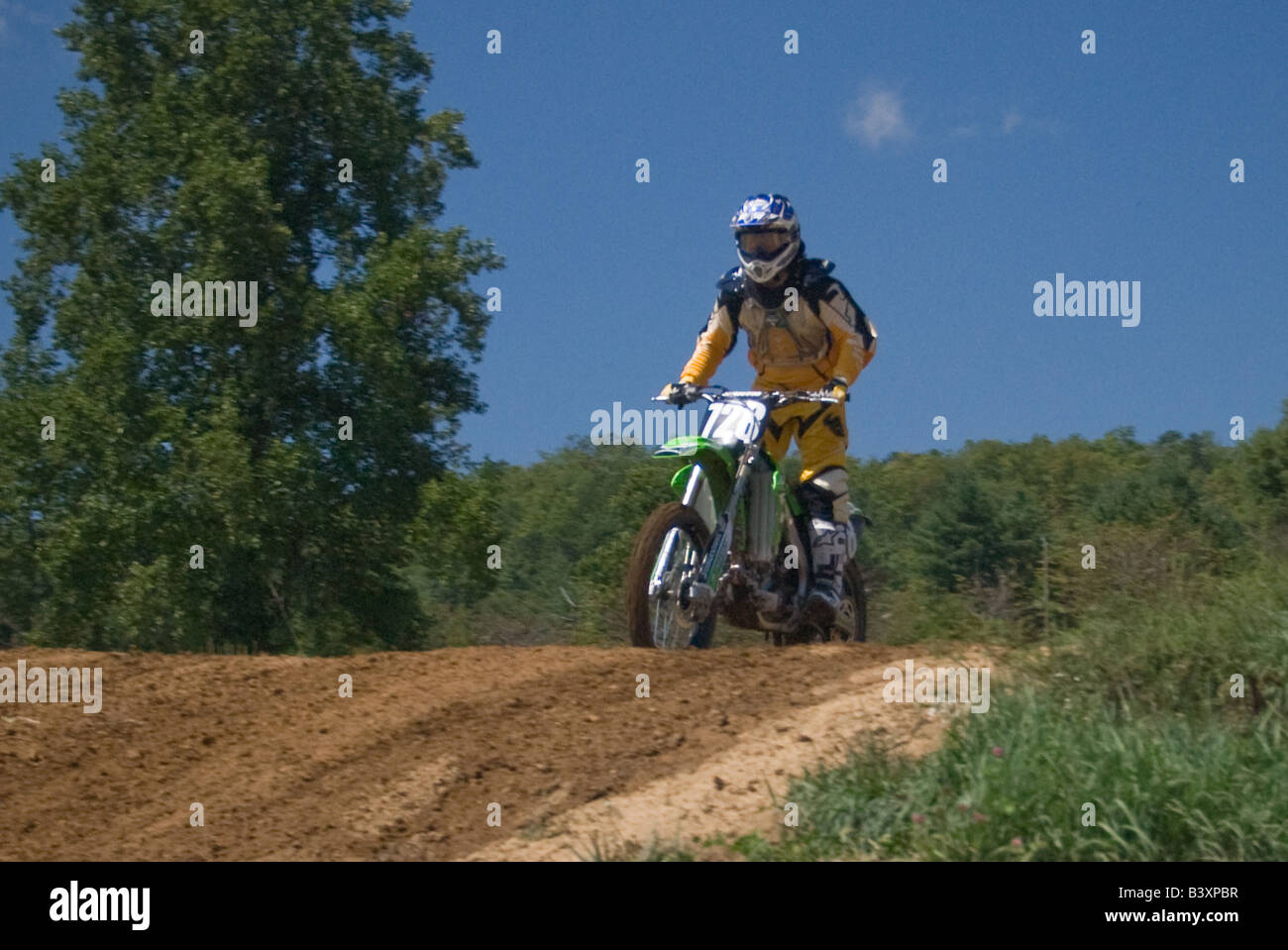 Man jumping on a motocross track with sky in the background Stock Photo ...