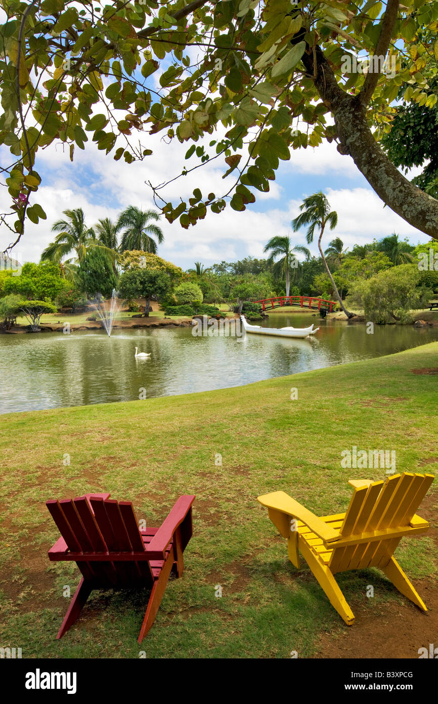 Two chairs overlooking boat and swan on pond at Smith s Tropical ...