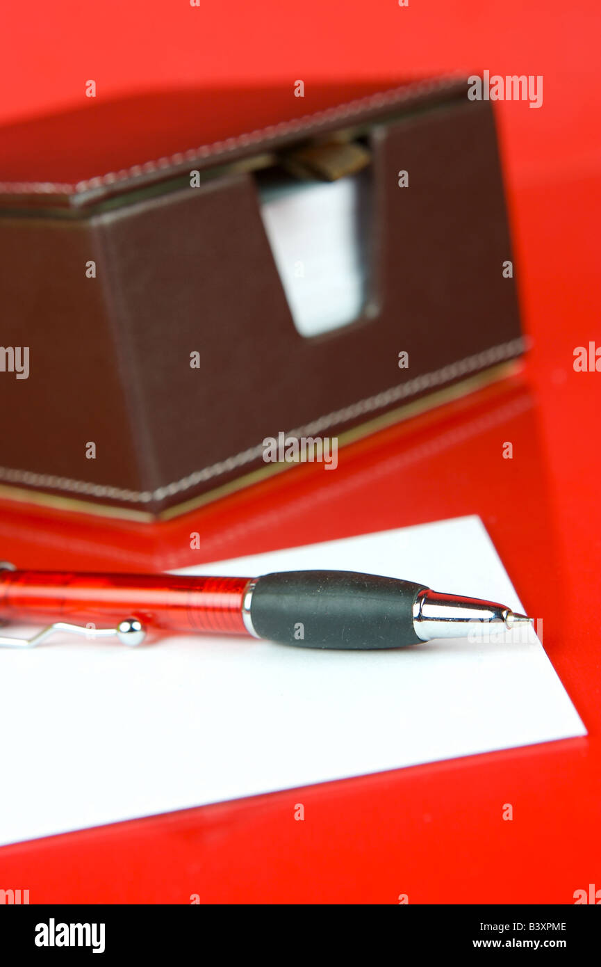 A note block isolated against a red background Stock Photo - Alamy