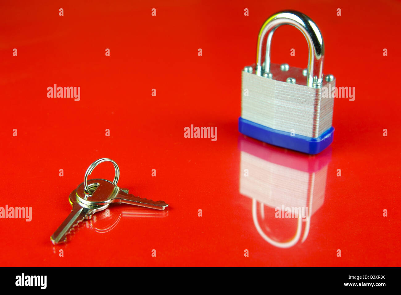 A padlock isolated against a red background Stock Photo - Alamy